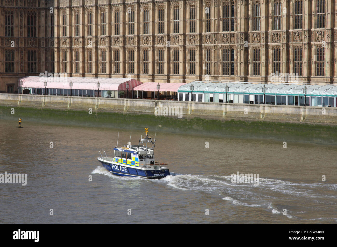 A Metropolitan Police motor launch on the River Thames at the Houses of ...
