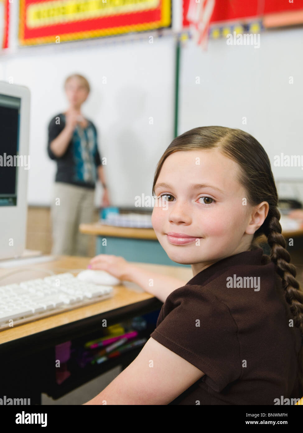 Elementary student sitting at desk in classroom Stock Photo - Alamy