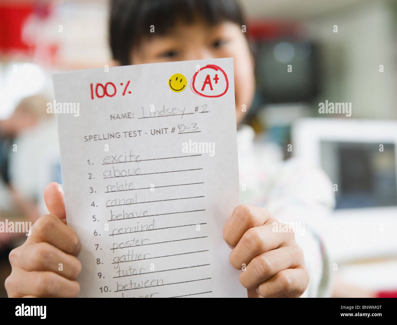 Elementary student holding an A grade paper Stock Photo - Alamy