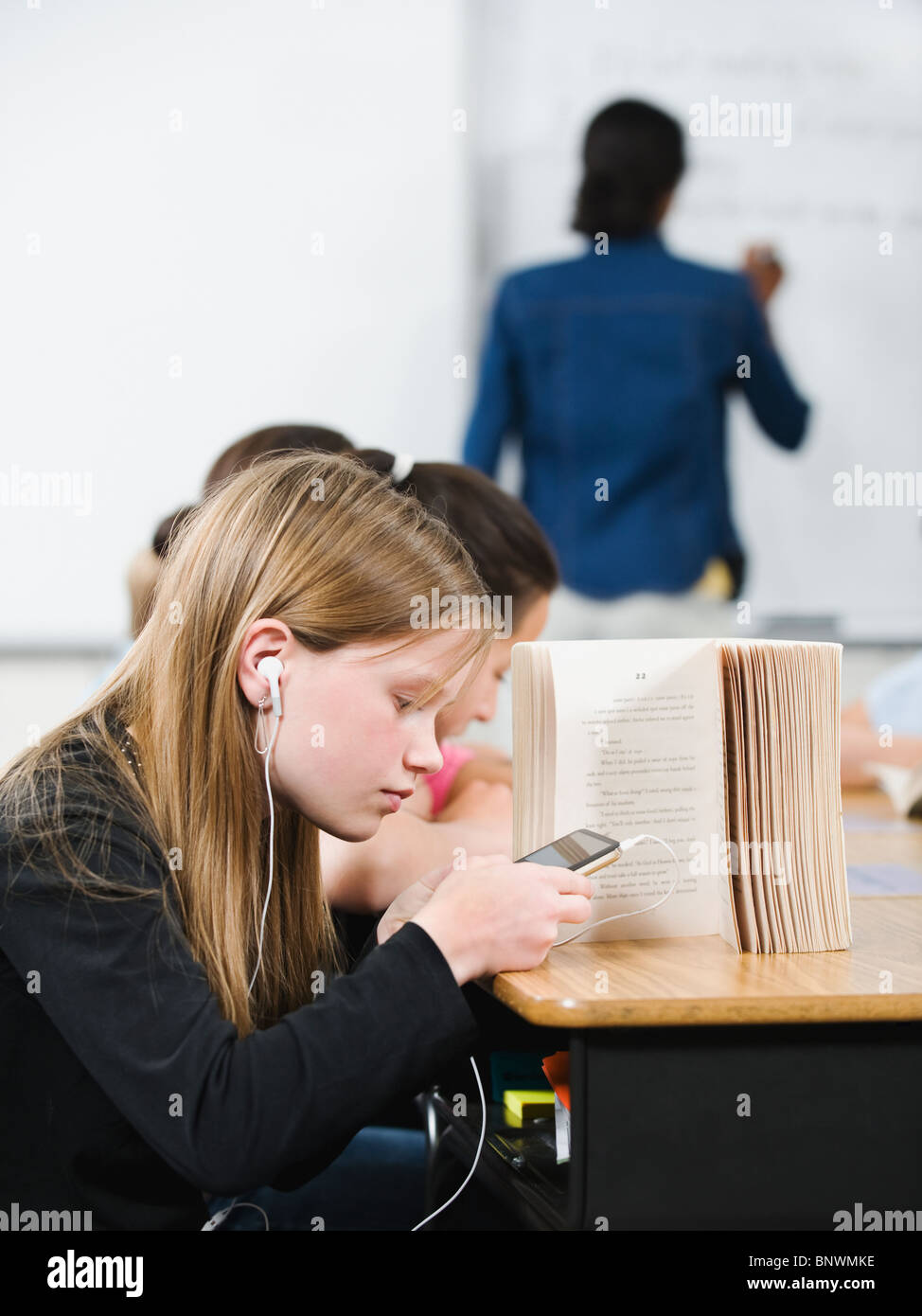 Student texting in classroom Stock Photo - Alamy