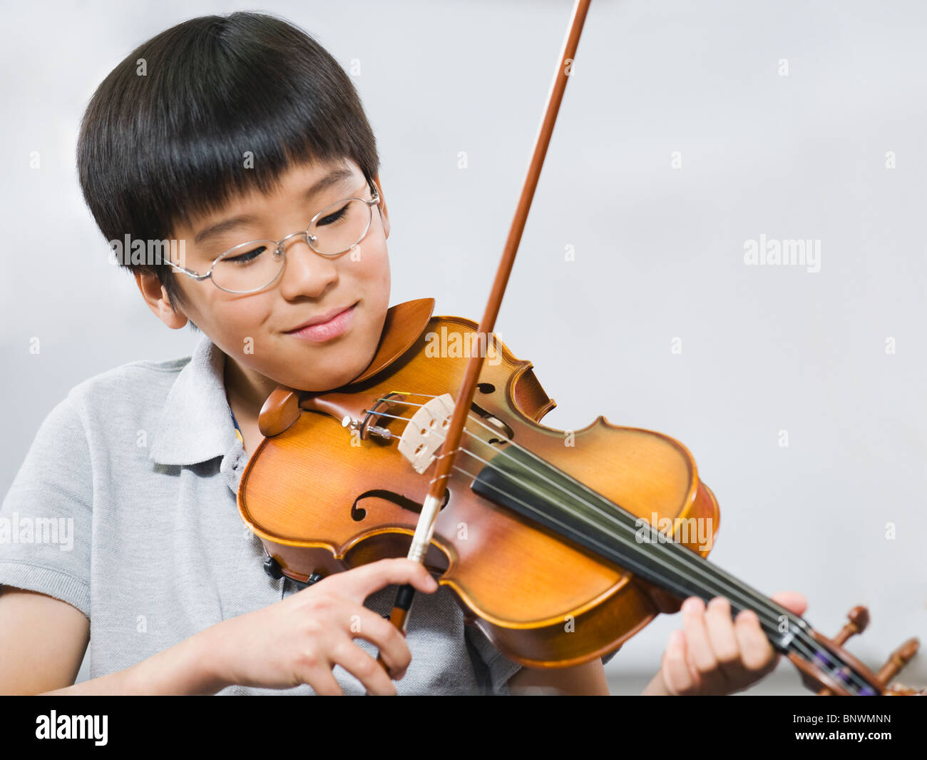 Elementary school student playing violin in music class Stock Photo - Alamy