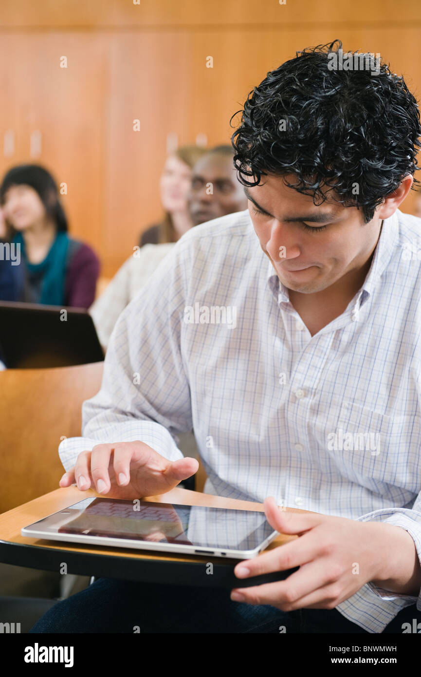 College students taking notes in lecture hall Stock Photo - Alamy