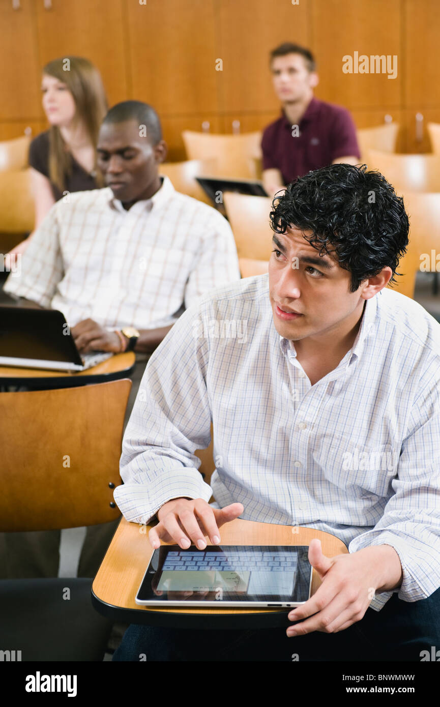 College students taking notes in lecture hall Stock Photo - Alamy