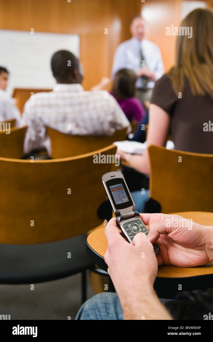 College student texting in lecture hall Stock Photo - Alamy