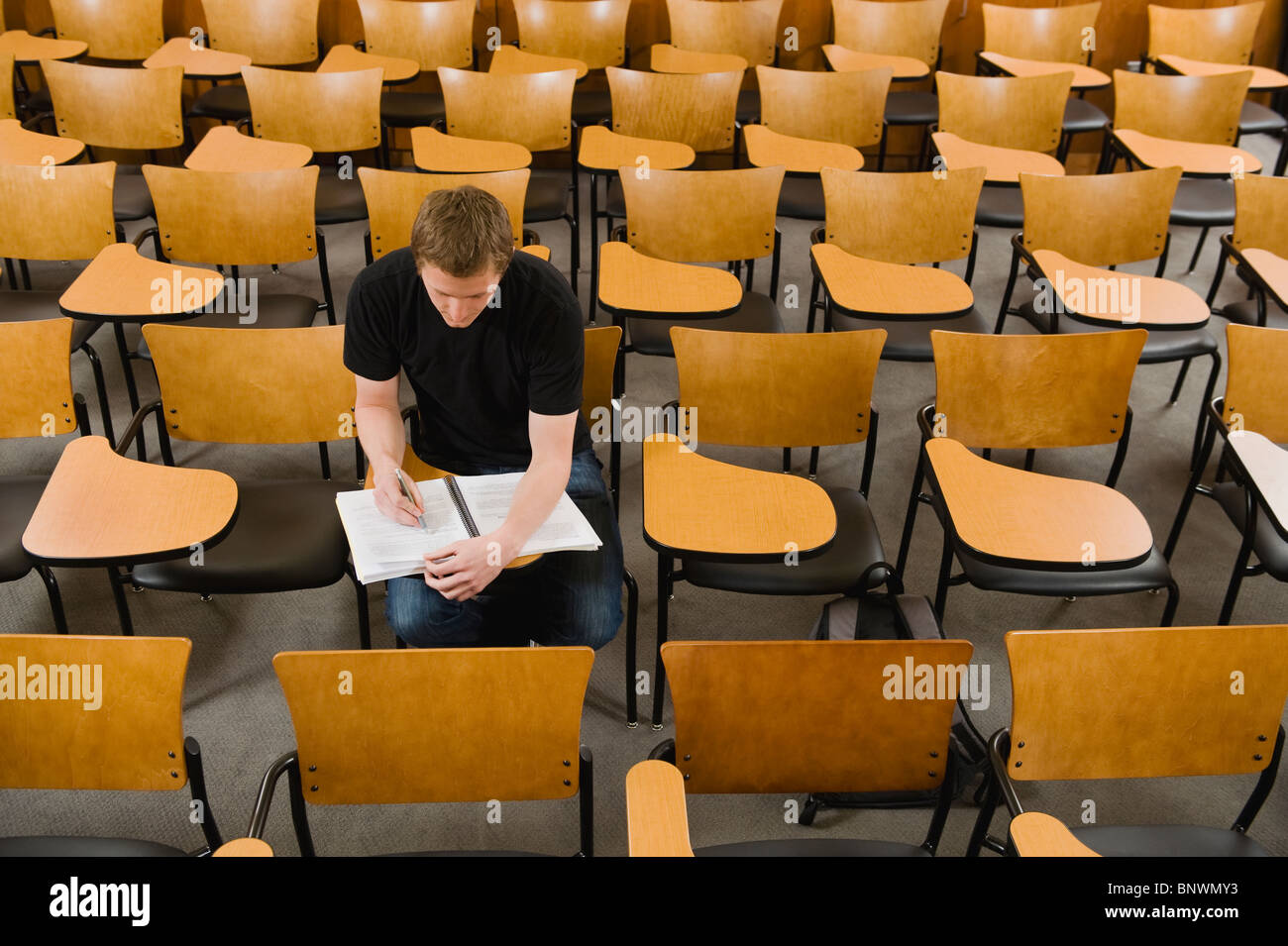 Last student left in college lecture hall Stock Photo - Alamy