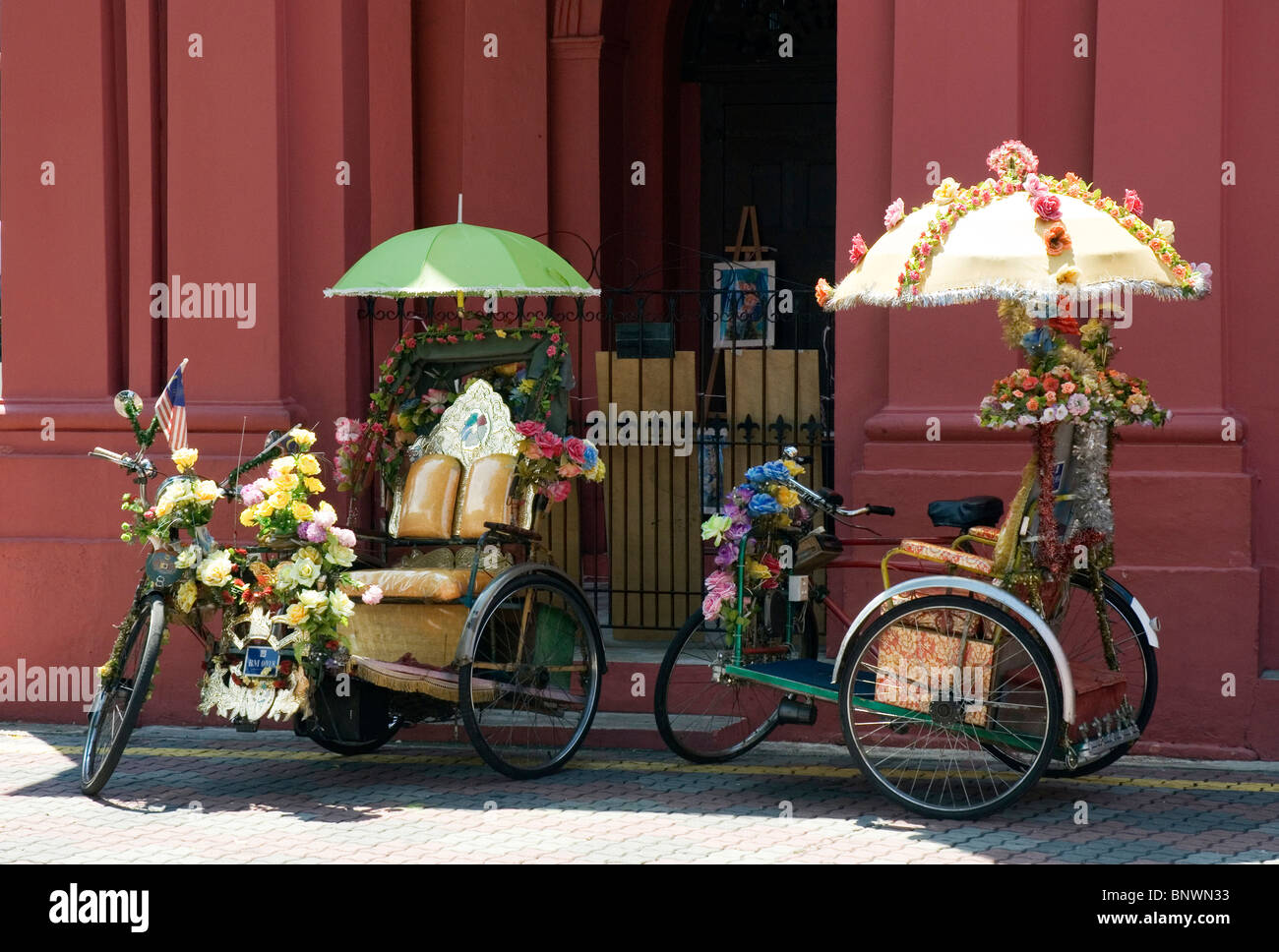 Two cycle rickshaws with parasols and decorated with flowers hi-res ...
