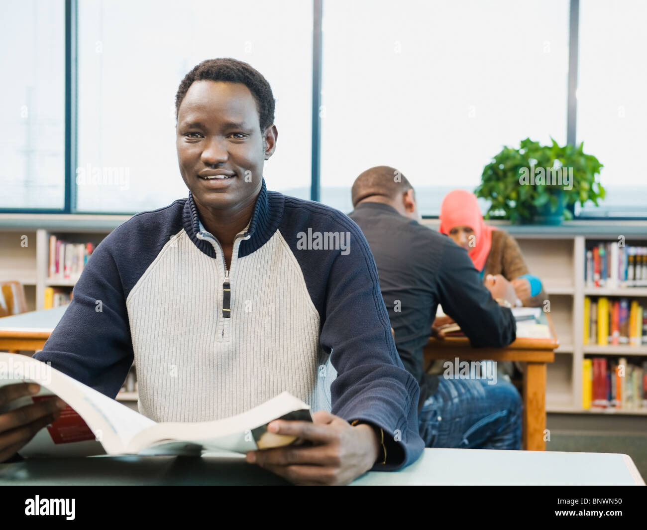 Adult sitting at desk at learning center Stock Photo - Alamy