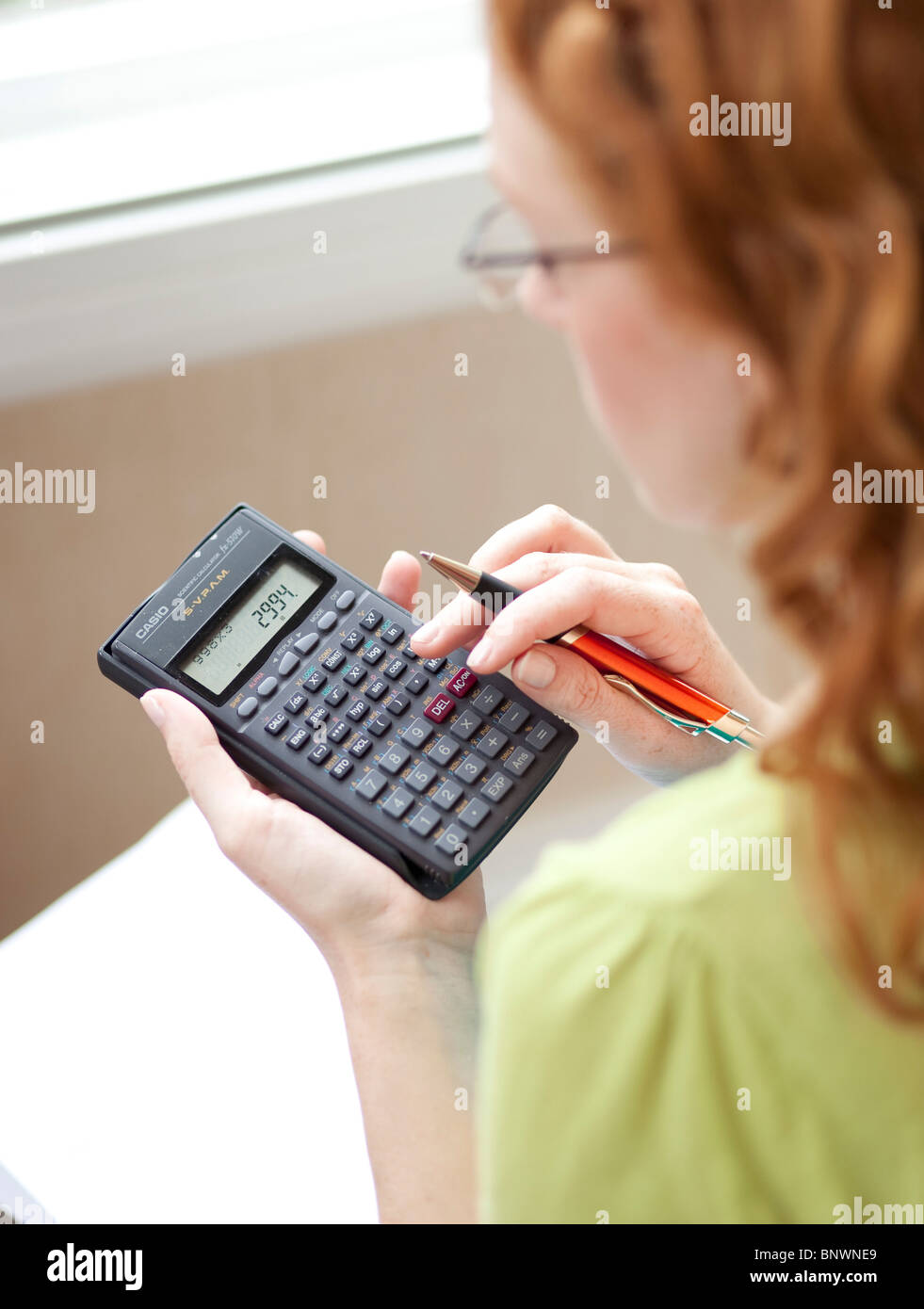 Woman with calculator Stock Photo - Alamy