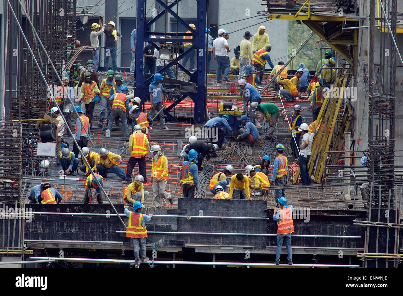 A large construction crew working on a new office block in the heart of ...