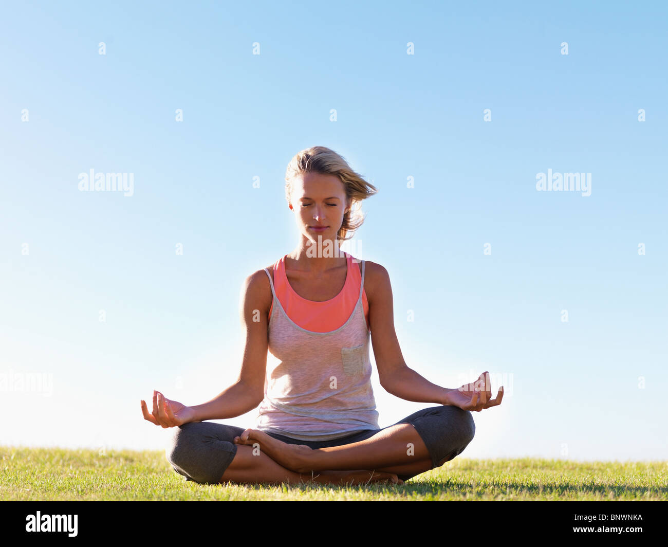 Woman meditating outside Stock Photo - Alamy