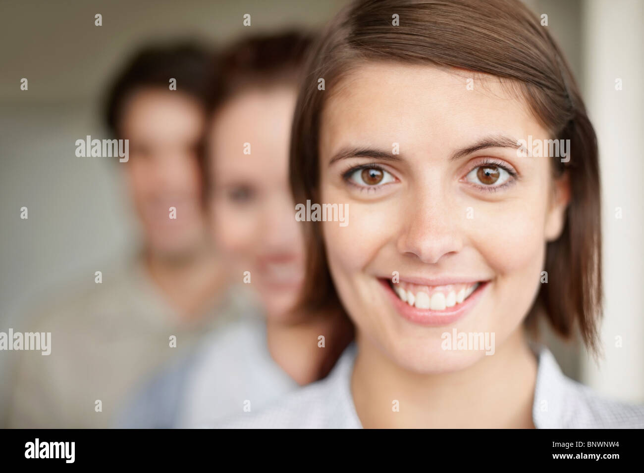 three people standing in a row Stock Photo - Alamy