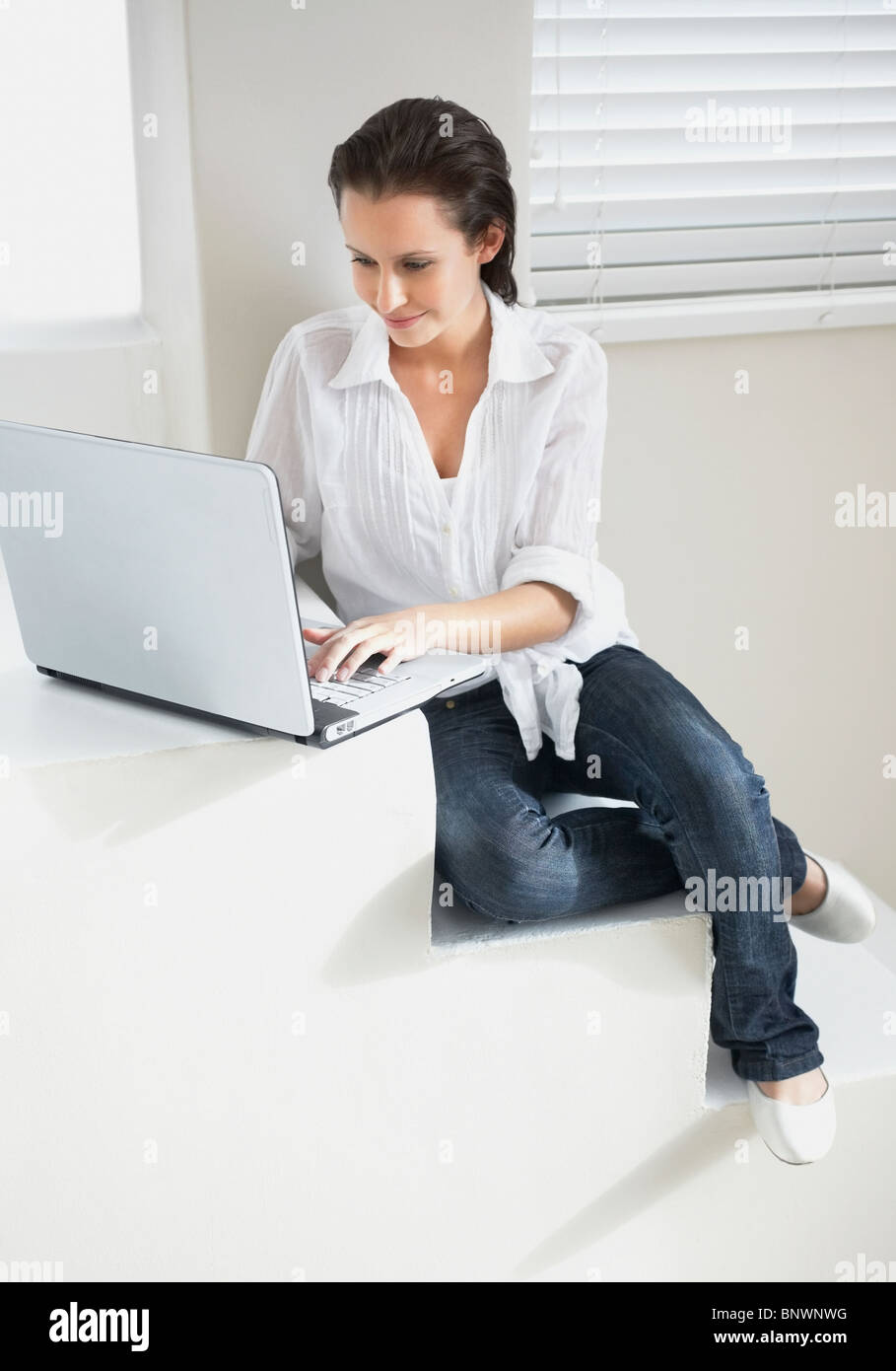 Woman typing on laptop Stock Photo - Alamy