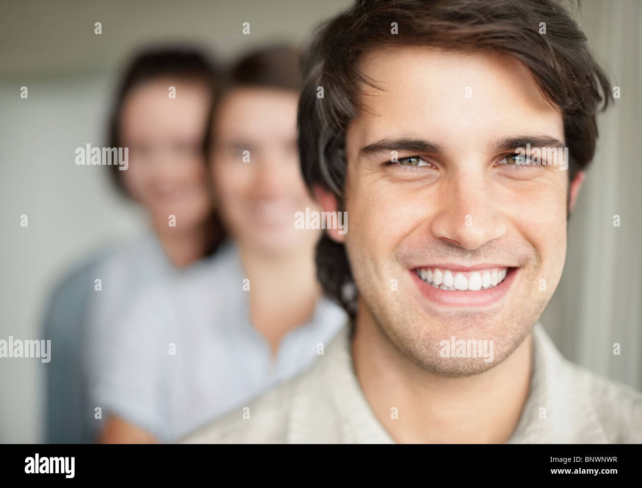 three people standing in a row Stock Photo - Alamy