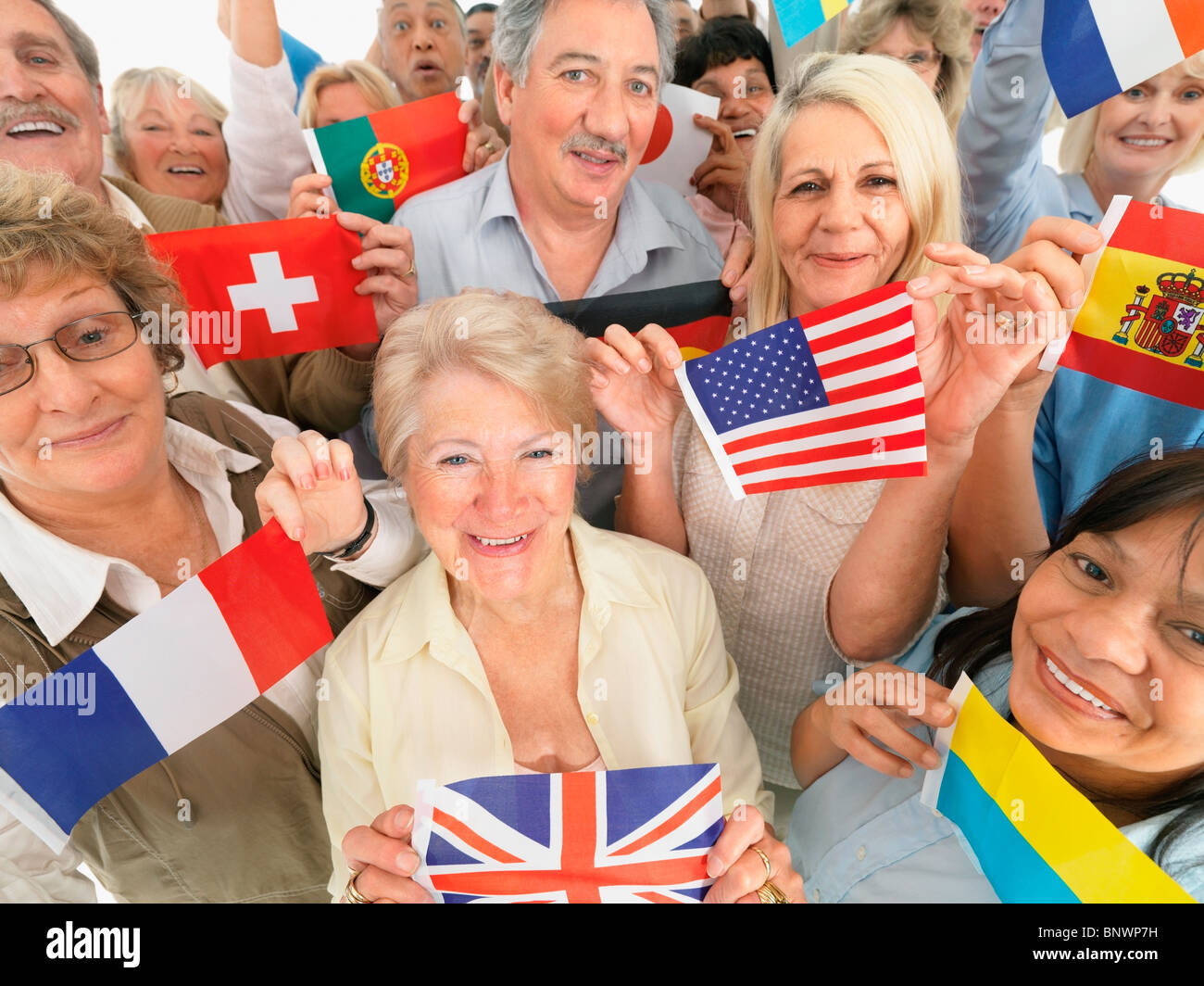 A group of people holding small flags Stock Photo - Alamy