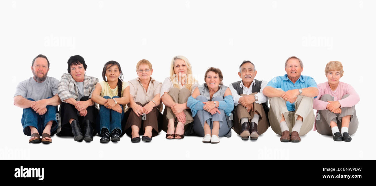 A group of people sitting on the floor in a row Stock Photo - Alamy