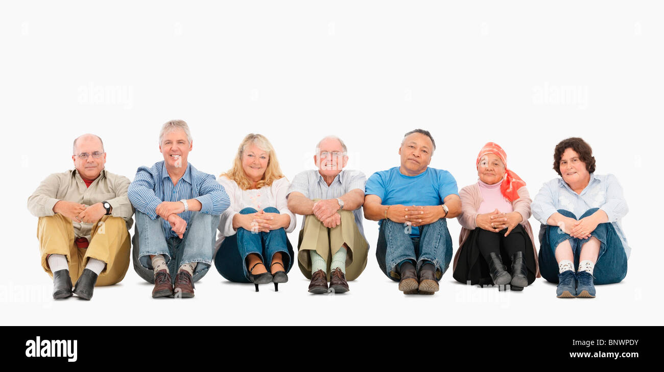 A group of people sitting on the floor in a row Stock Photo - Alamy