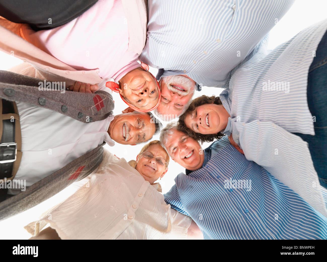 A group of people huddled together Stock Photo - Alamy