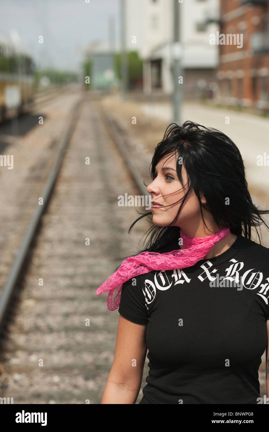 Woman standing on railroad tracks Stock Photo - Alamy