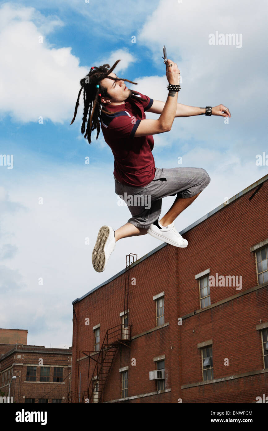 Teenage boy jumping in air Stock Photo - Alamy