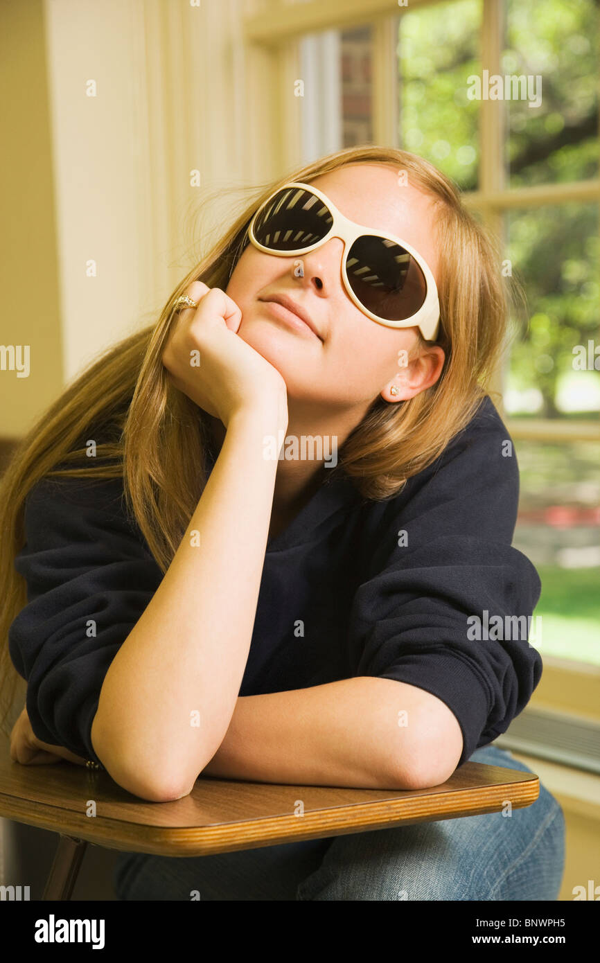 Teenage student daydreaming at her desk Stock Photo - Alamy