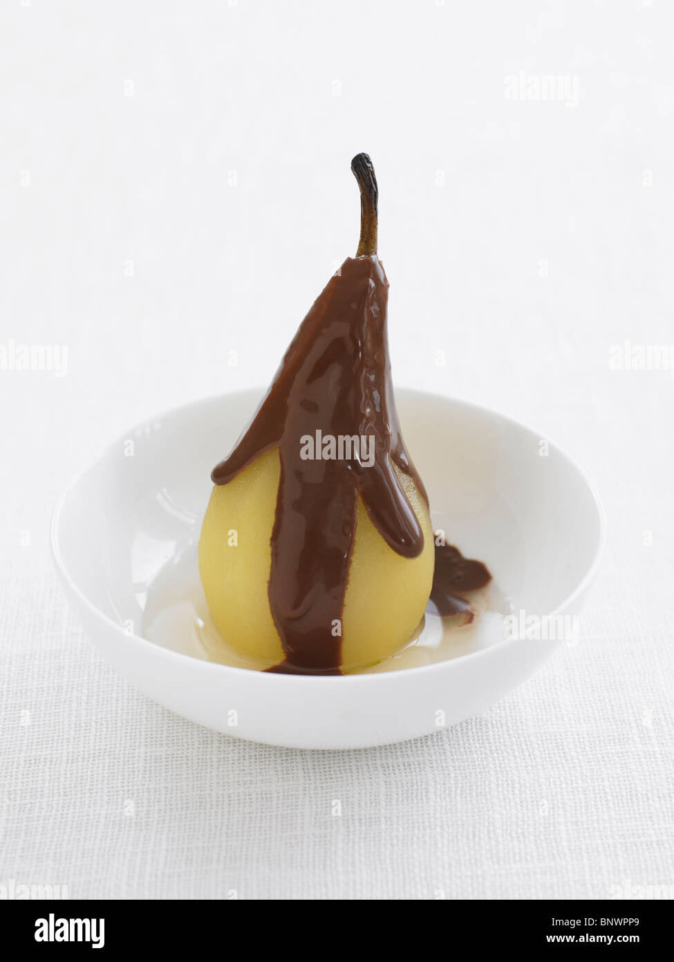 Poached pears with rich chocolate sauce hi-res stock photography and ...