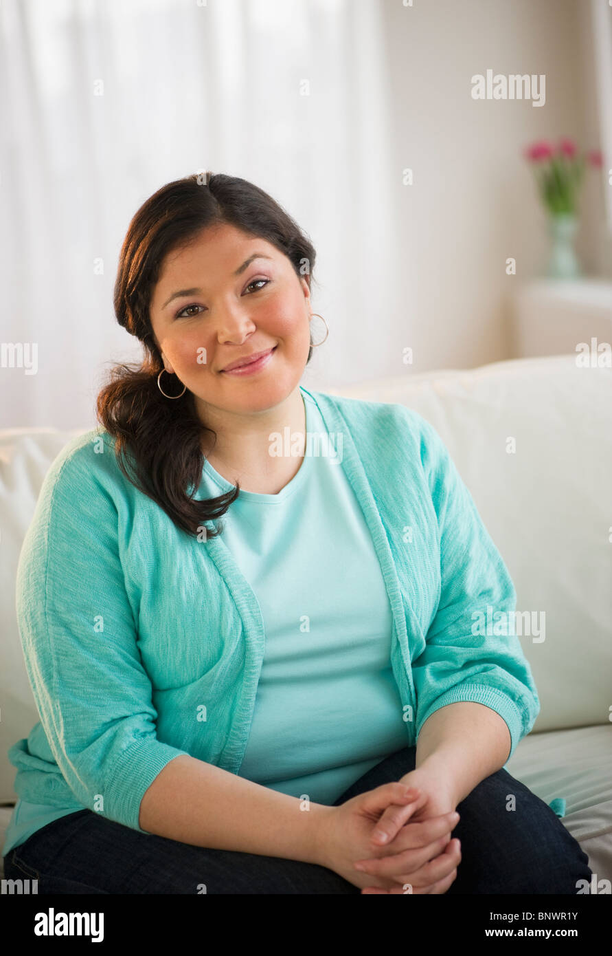 Overweight woman sitting on couch Stock Photo - Alamy