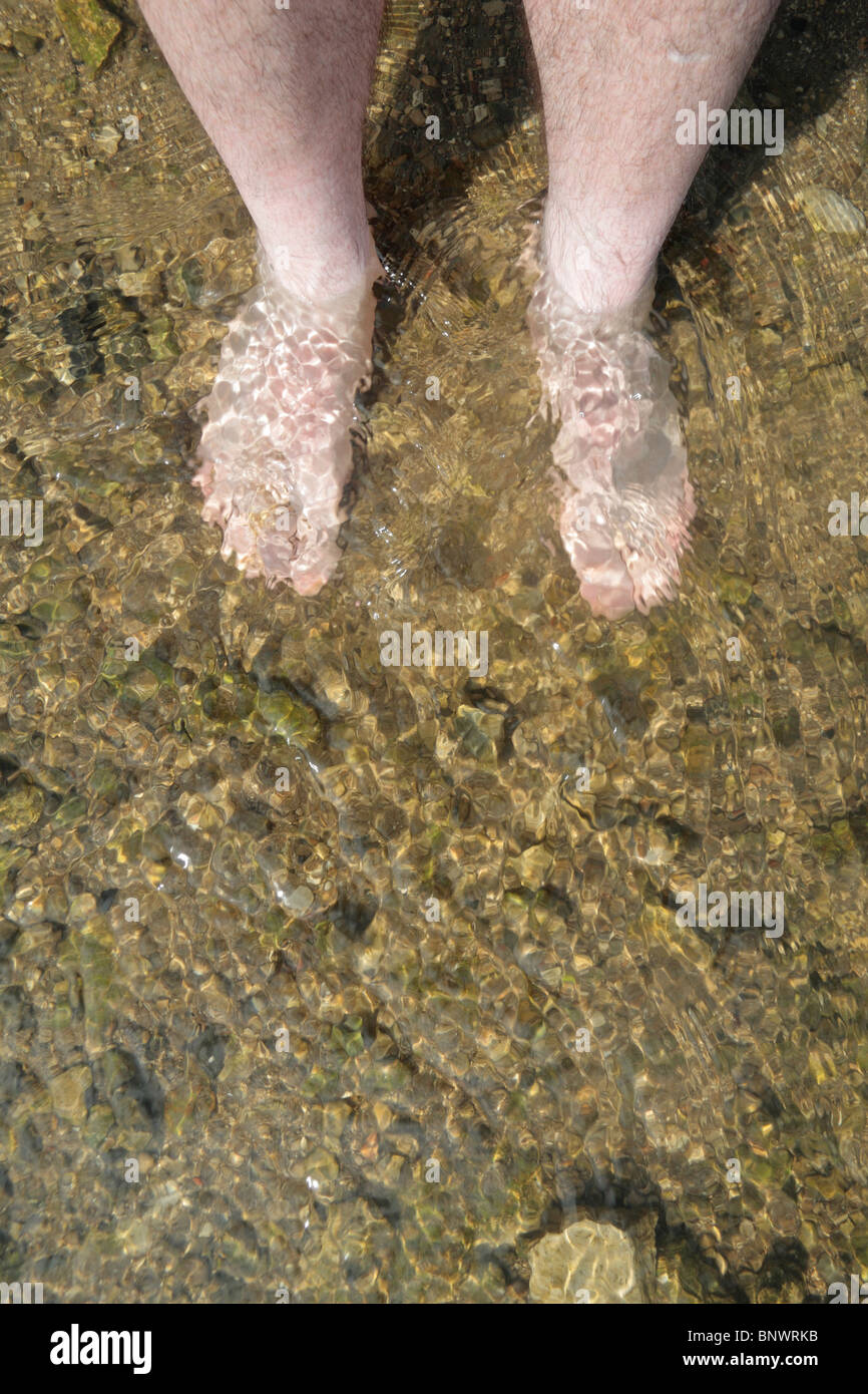 A pair of cold (very cold) white feet in a clear water stream in Dorset ...