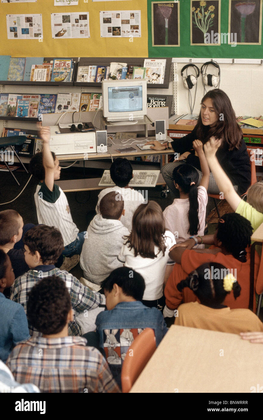 Primary school children and teacher in classroom scene Stock Photo - Alamy