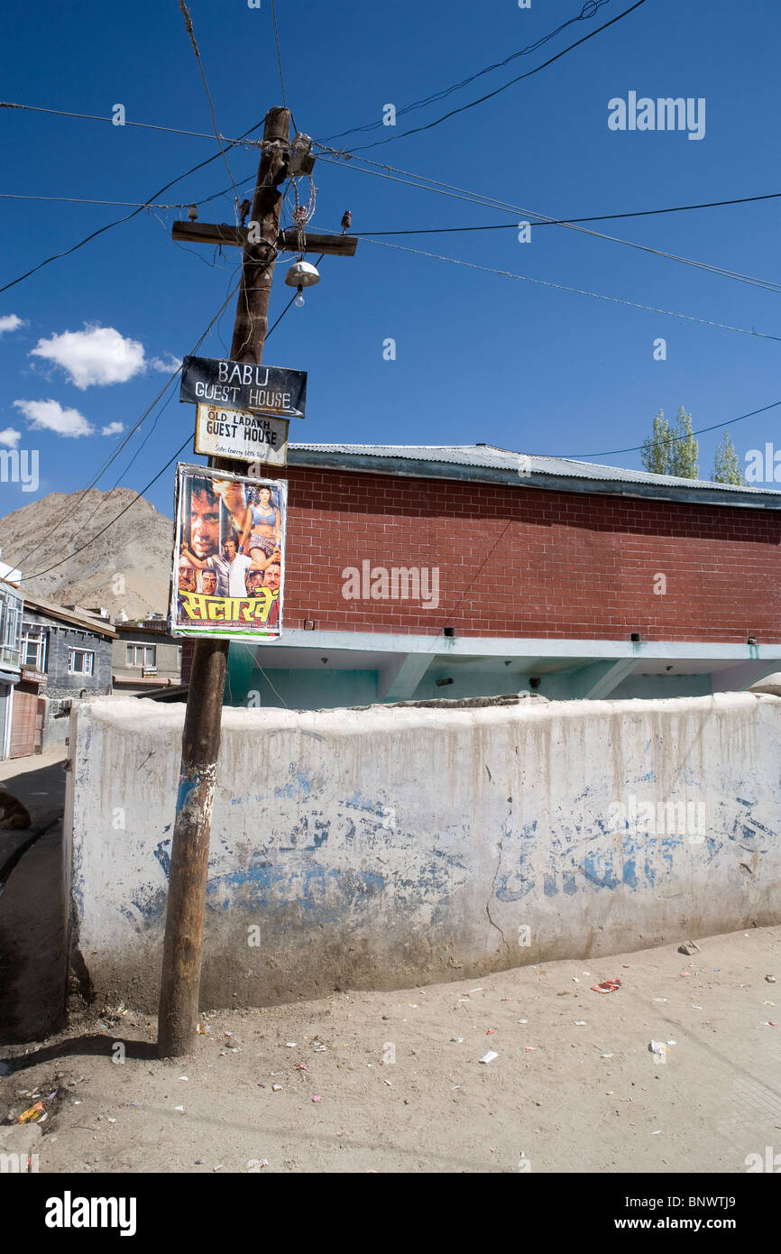 Bollywood posters and guest house signs on a utility pole in Leh, India ...
