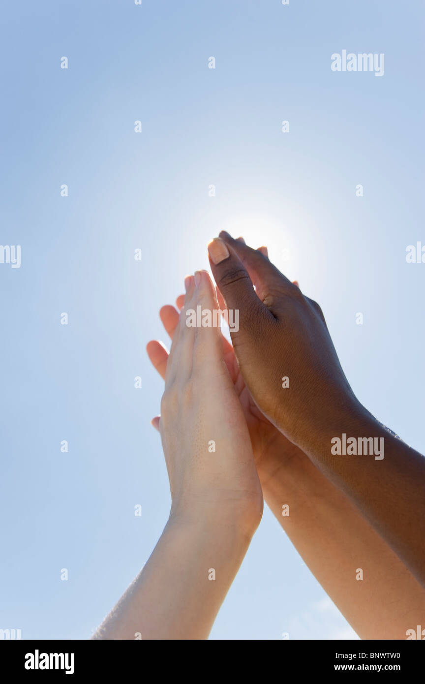 Hands held up in front of sunshine Stock Photo - Alamy