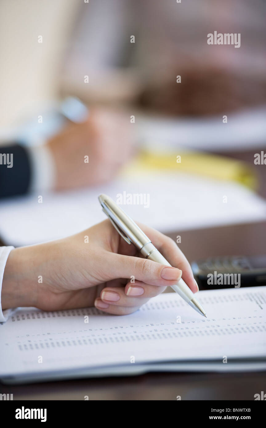 Hand holding pen Stock Photo - Alamy