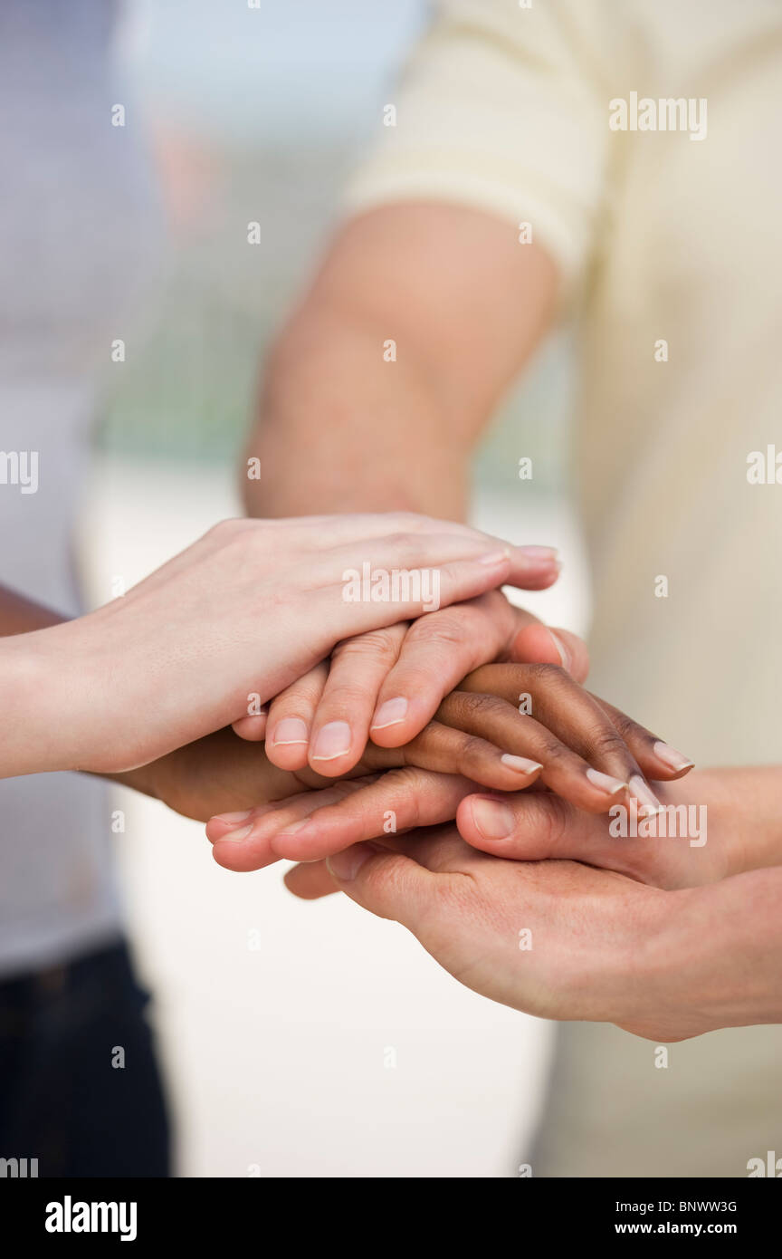 Hands atop one another Stock Photo - Alamy