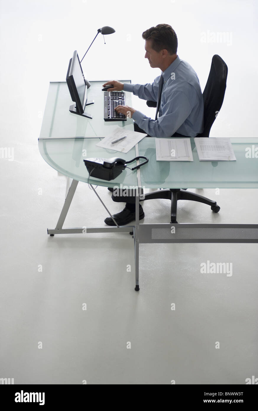 Man working at desk Stock Photo - Alamy