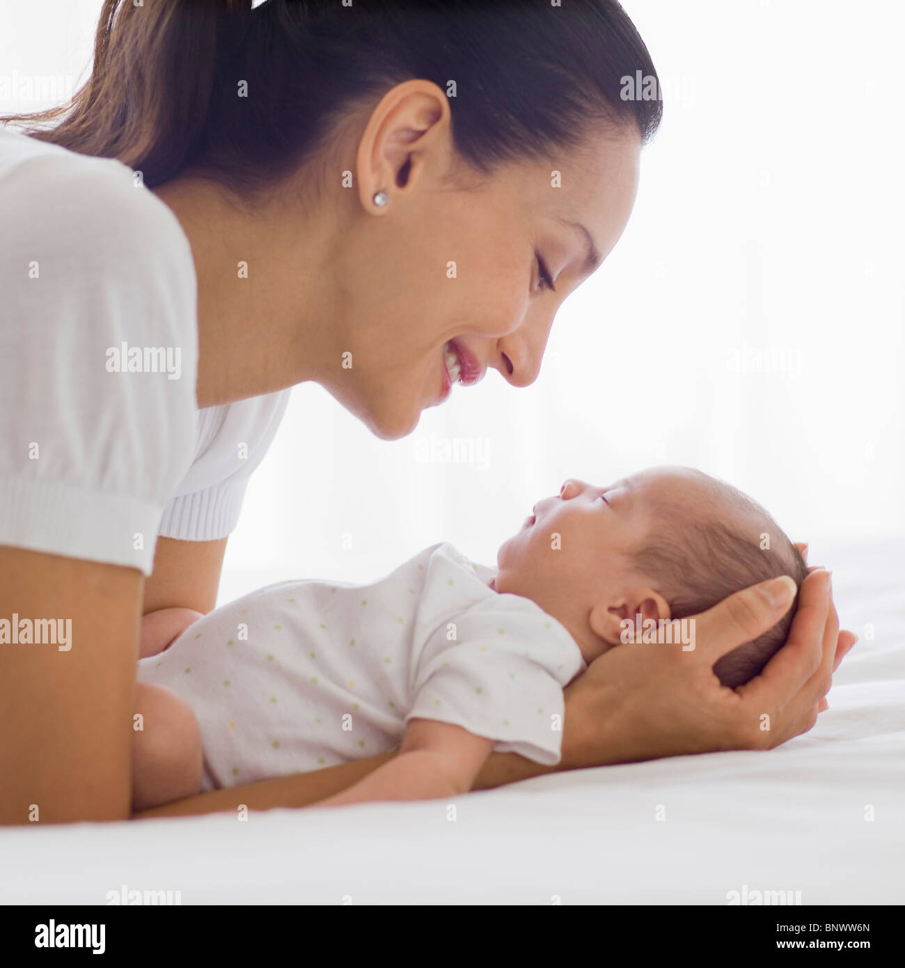 Mother holding her sleeping baby Stock Photo - Alamy