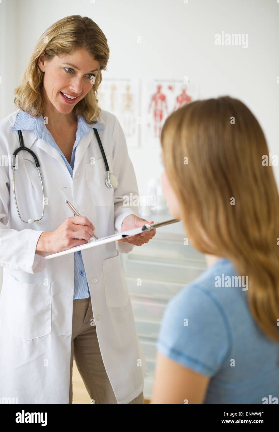 Doctor talking to patient in exam room Stock Photo - Alamy