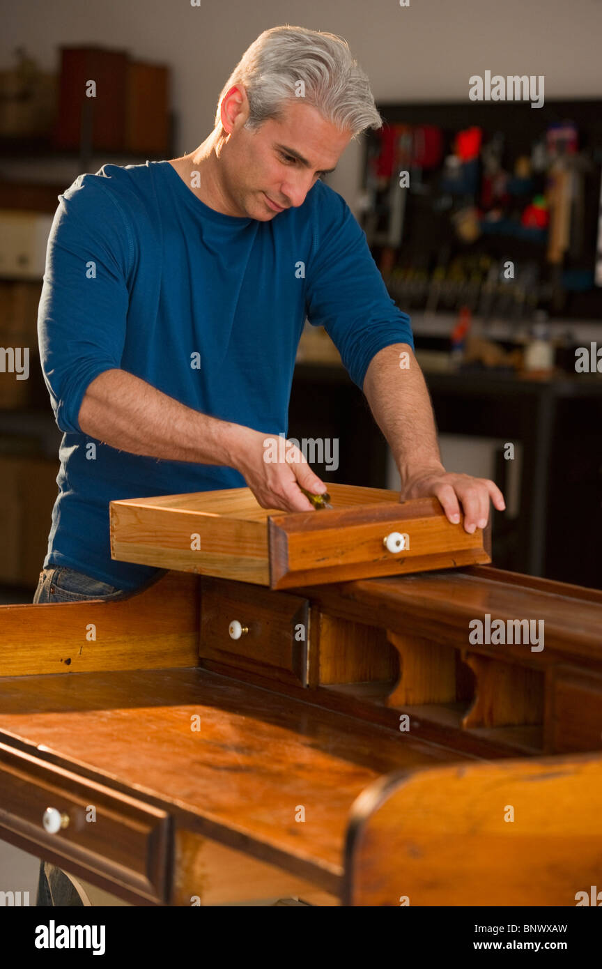 Craftsman fixing a piece of furniture Stock Photo - Alamy