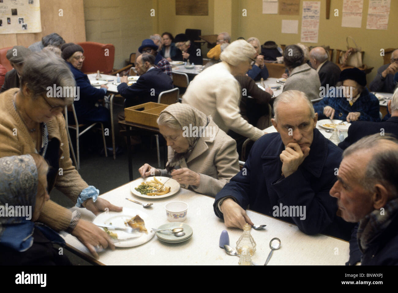 Historical 70's image of old people eating at an old peoples day center ...