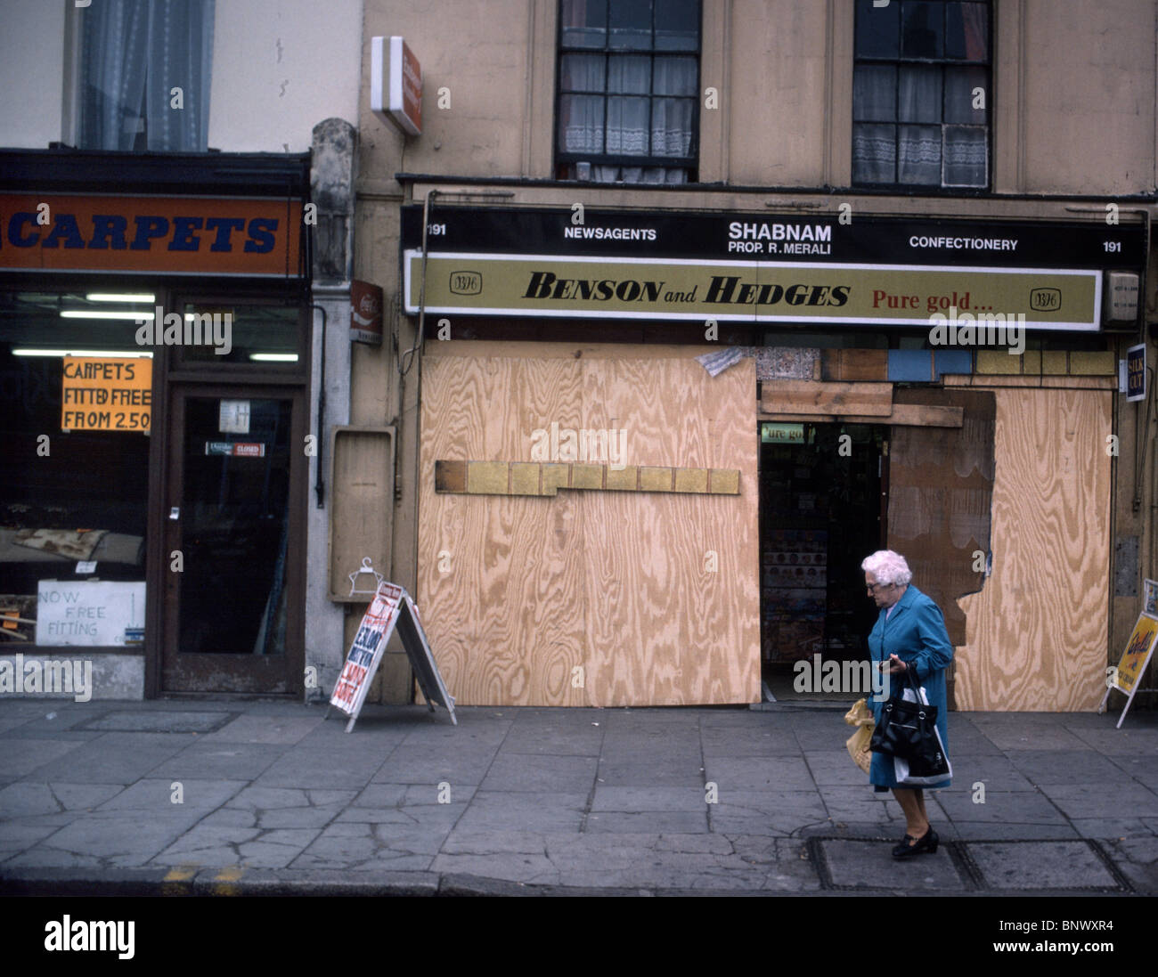 Old convenience store boarded up in a rundown street Stock Photo - Alamy