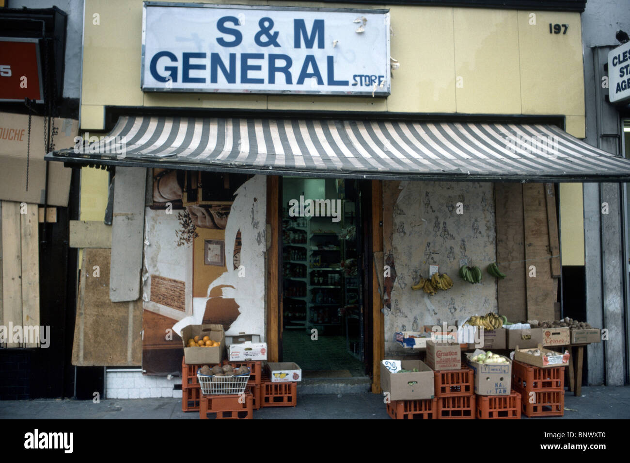 Old run down shop with some fresh produce in front and a sign saying S ...