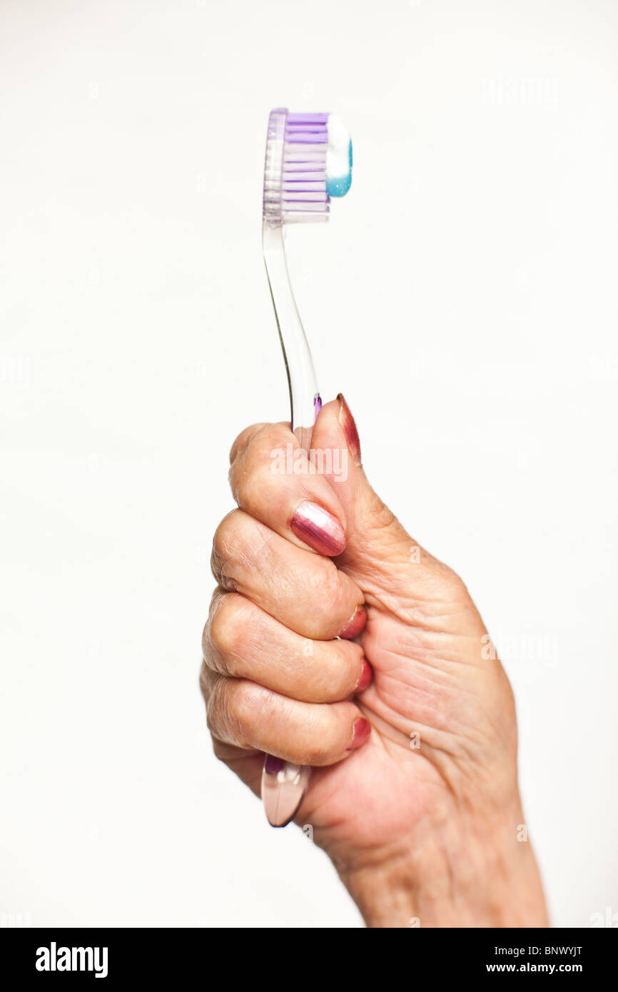 A woman's hand holding a tooth brush loaded with tooth paste Stock ...