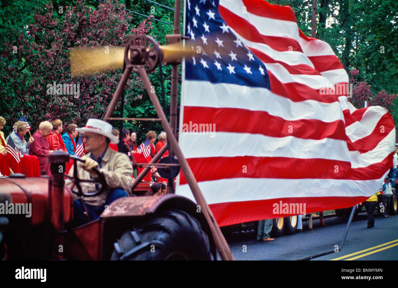 Large American flag pulled by tractor in small town parade Stock Photo ...