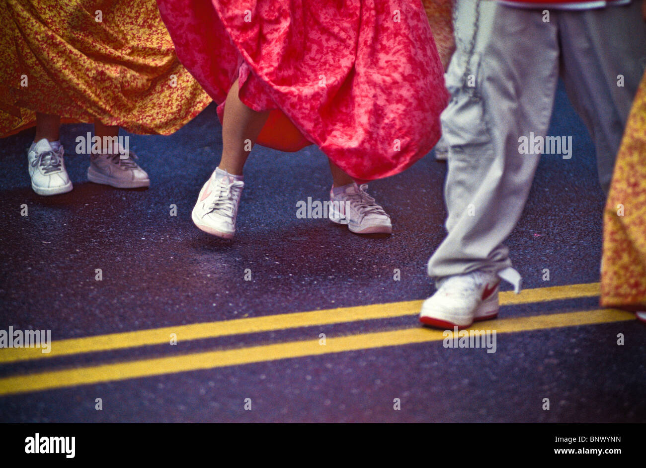 Group of dancers march perform in small town parade Stock Photo - Alamy