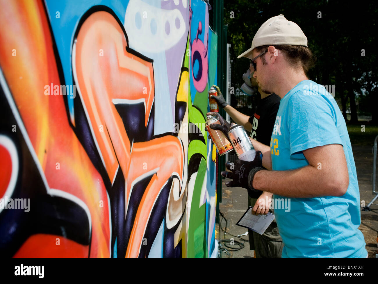 Graffiti artists at the Brent respect festival making a mural with ...
