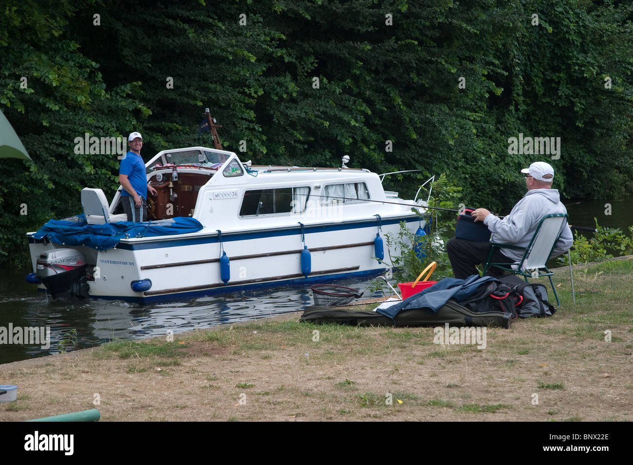 boater leisure boat talking smiling fisherman Stock Photo - Alamy
