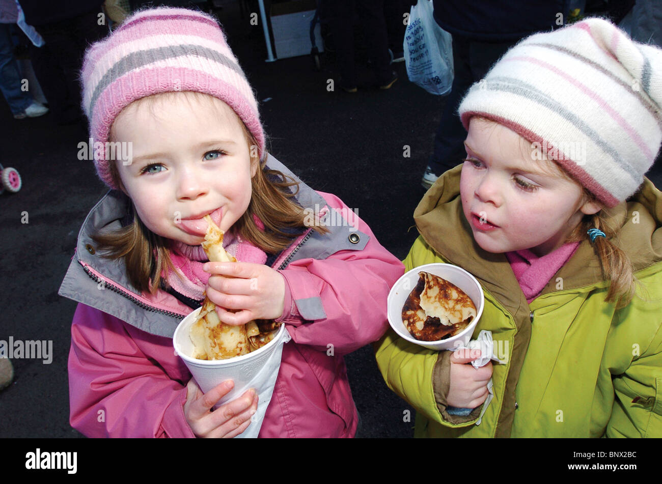 Charlotte Cooke (L) and Ruby Sutton, both 3 years old, tuck in at the ...