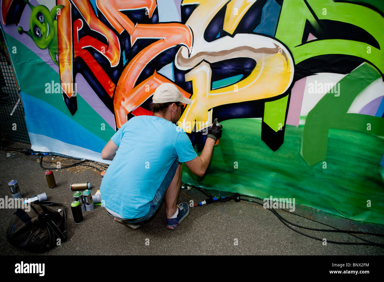 Graffiti artists at the Brent respect festival making a mural with ...
