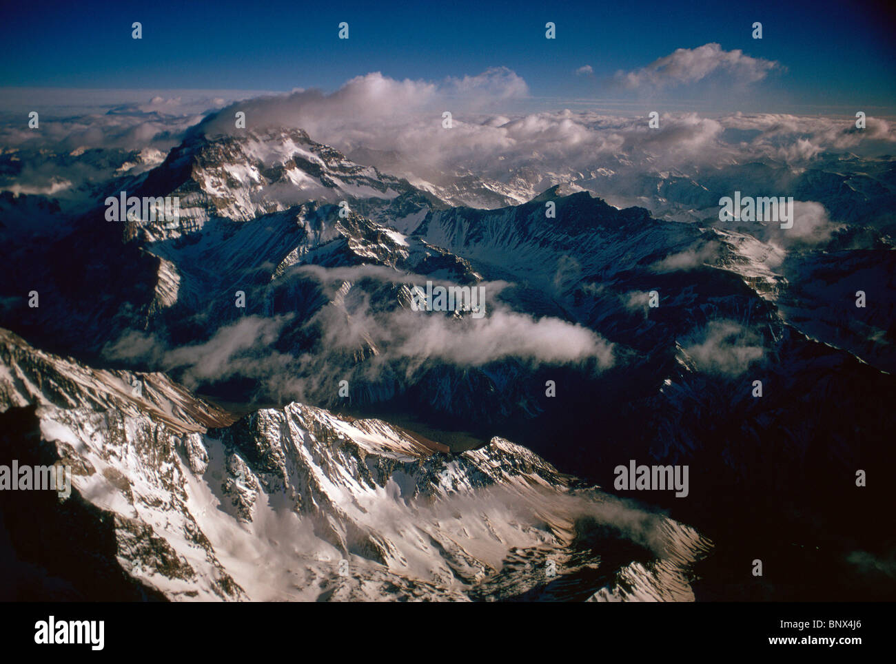 A snow plume streaks from the crest of Aconcagua, the highest mountain ...