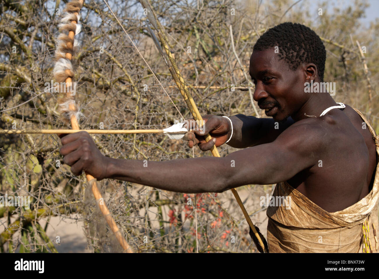 Hadza man practicing archery, Tanzania Stock Photo - Alamy