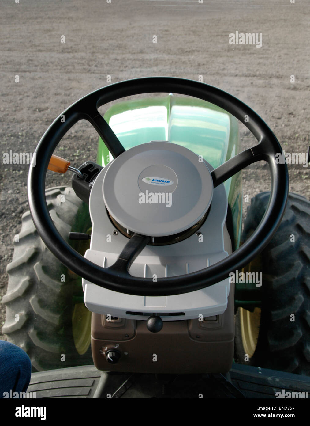 A tractor driver with GPS navigation for accurate field grading Stock ...
