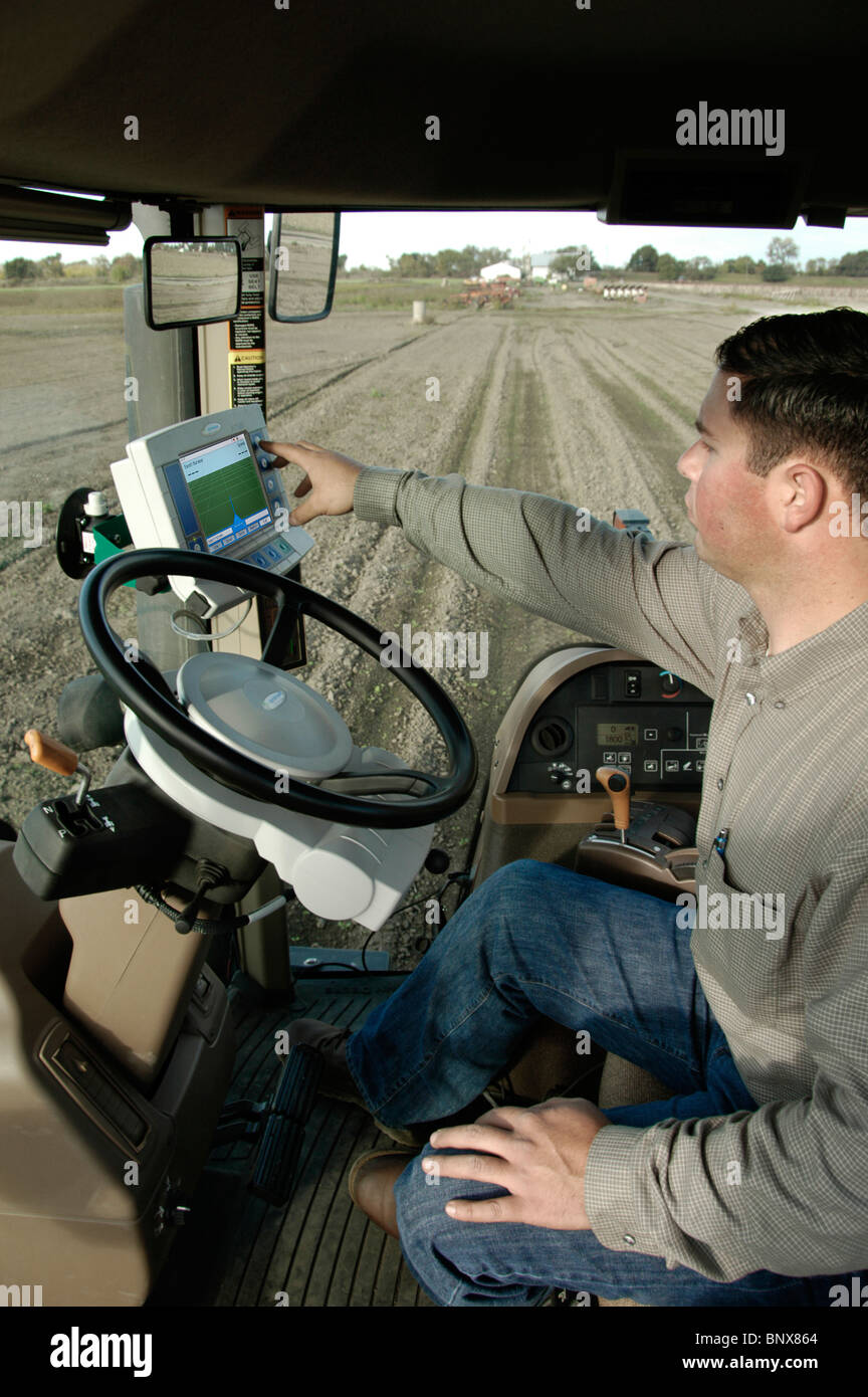 A tractor driver with GPS navigation for accurate field grading Stock ...